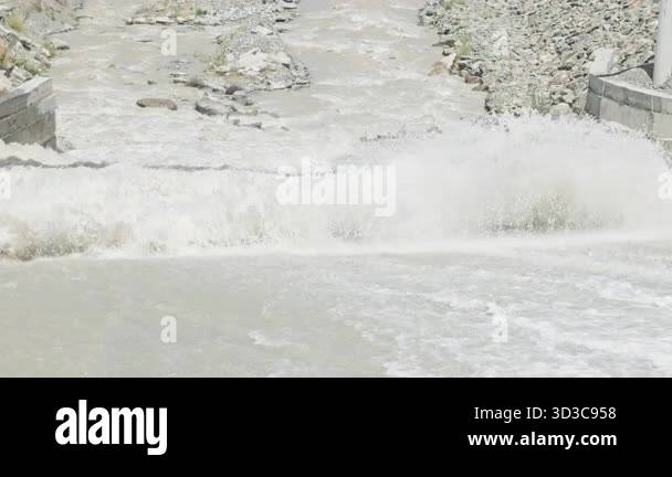 row of chute dentate blocks in concrete water spillway channel slope ...