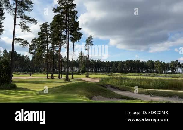 Scenic golf course landscape reveals vibrant greenery and sandy bunkers ...