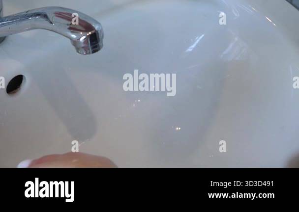 Sequence of hands positioned under a faucet, gradually zooming in to ...