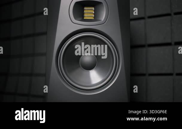 Front view of a black studio monitor speaker cone vibrating from low ...