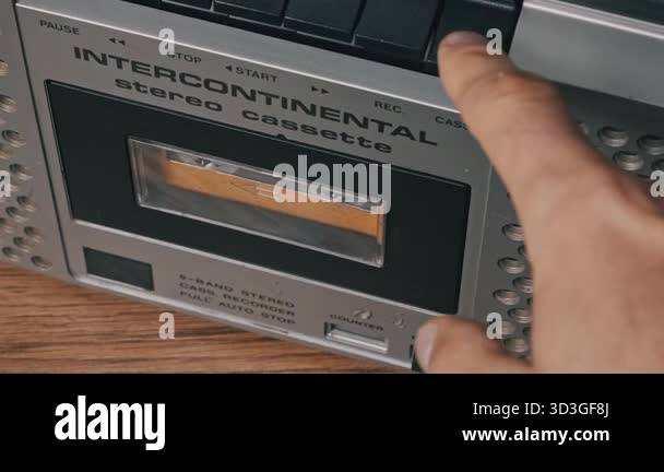 Close-up view hand ejecting and removing vintage audio cassette from ...