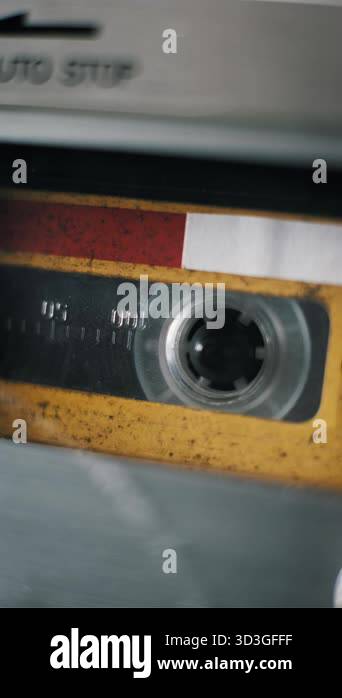 Vertical, extreme close-up of a vintage audio cassettes transparent ...
