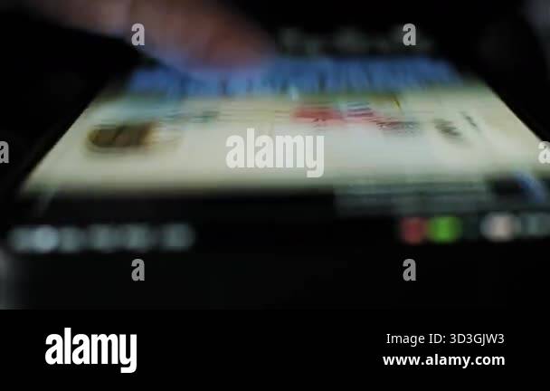 Low angle macro shot of a finger rapidly scrolling a social media feed ...