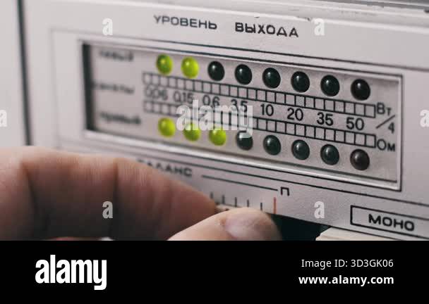 Macro shot hand adjusting a balance slider on a vintage audio amplifier ...