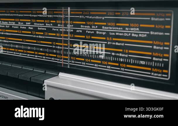 Close-up of tuning a vintage radio receivers analog frequency scale ...