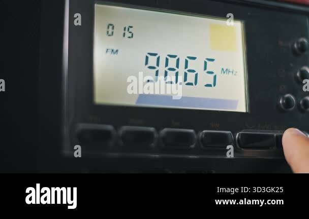 Macro of a finger cycling through FM SW and LW radio bands on a digital ...