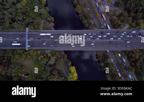 Aerial view showing busy highway traffic crossing a bridge over a river ...