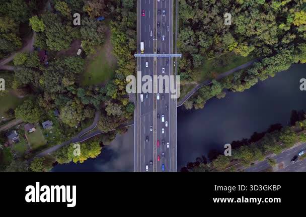 Aerial view showing busy highway traffic crossing a bridge over a river ...