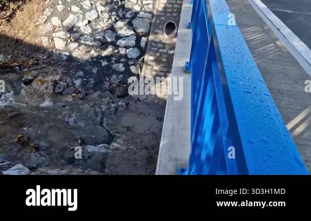 freeway bridge drainage. A sound-absorbing wall with holes lets water ...