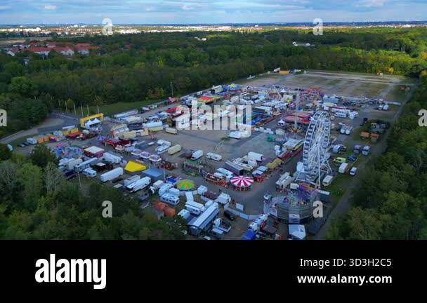 Aerial view of an outdoor forest fairground, funfair, carnival with ...