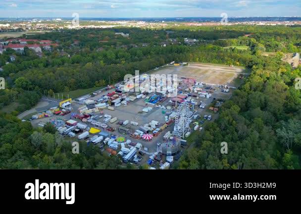 Aerial view of an outdoor forest fairground, funfair, carnival with ...