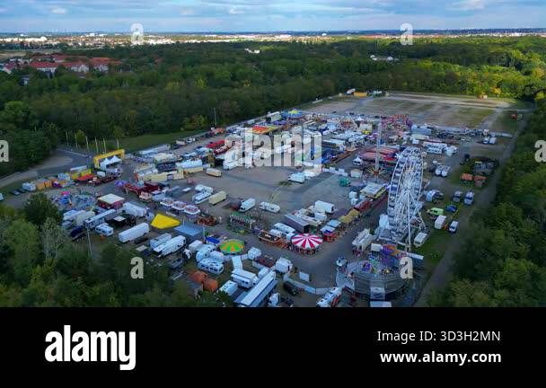 Aerial view of an outdoor forest fairground, funfair, carnival with ...