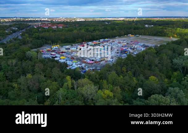 Aerial view of an outdoor forest fairground, funfair, carnival with ...