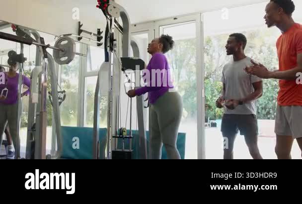 Exercising together at home gym, African American friends laughing ...