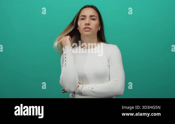 Woman thinking deeply, appears pensive and contemplative, wearing white ...