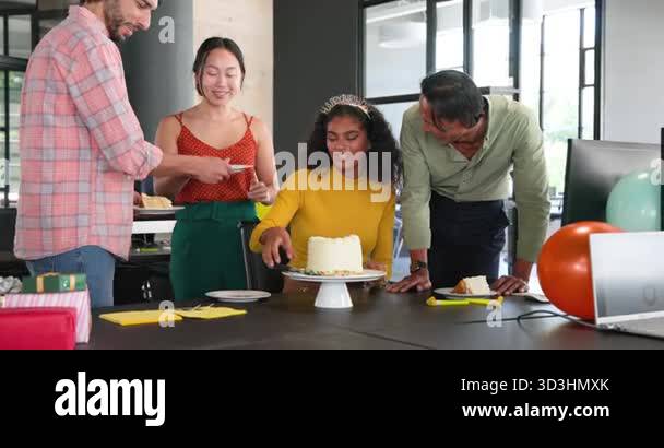 Happy colleagues celebrating birthday party and eating cake in an ...