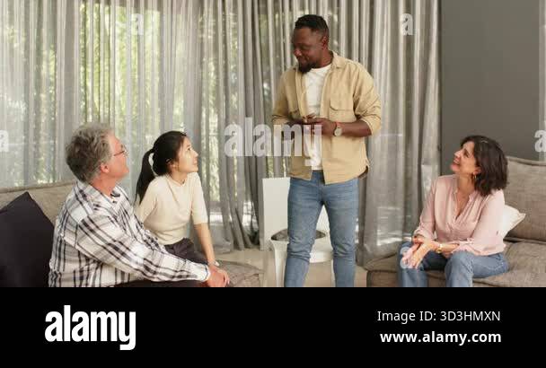 Happy male therapist handing statue to patient and taking pictures in ...