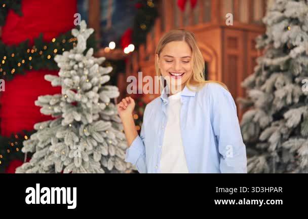Young woman expresses happy, excited emotions in festive Christmas ...
