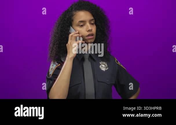 Officer talking on phone with serious expression, young woman in police ...