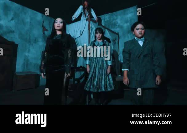 Dramatic dance performance with actors in dark costumes on stage inside ...
