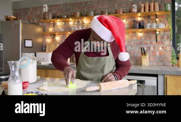 Dusting dough with flour, man is stamping leaf and circle shapes on ...