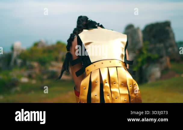 a female warrior in golden armor walked closer to a royal castle full ...