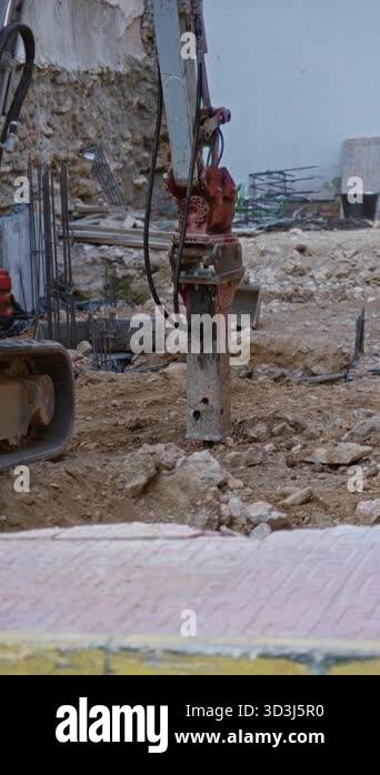 Construction excavator digging in an outdoor sunny setting shows ...