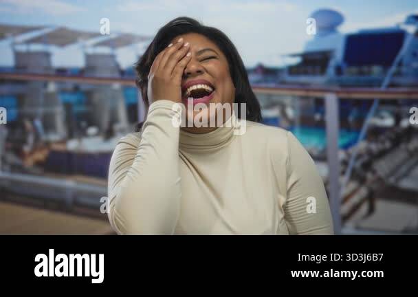 Woman laughing joyfully on a cruise ship, with a vibrant seaside ...