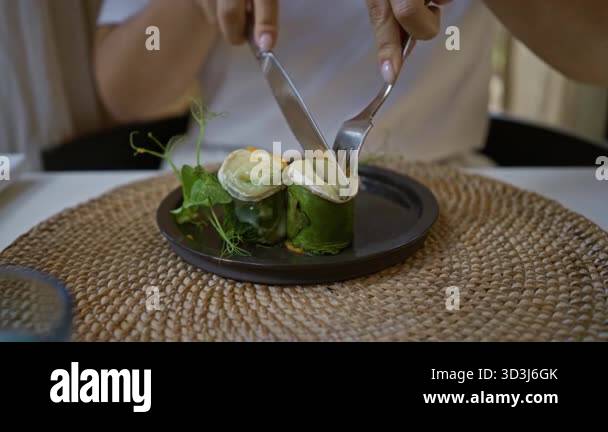 Woman eating delightful vegetarian dish at a mediterranean restaurant ...