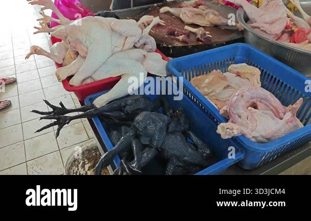 A bucket of slaughtered fresh black dressed chicken for sale at the ...