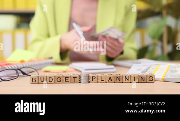 Hands are busy with calculations and notes as colorful sticky pads ...