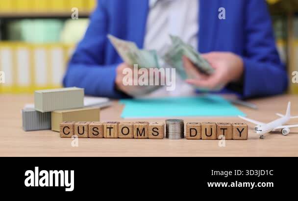 At a bustling office, someone counts cash while surrounded by custom ...