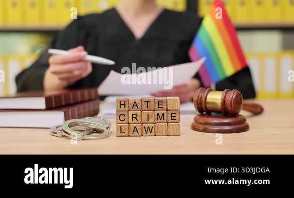 A judge prepares to discuss hate crime laws while surrounded by symbols ...