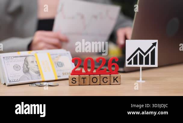 Individuals analyze stock market data while surrounded by cash and ...