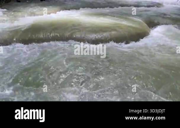 Powerful tropical waterfall flowing through lush green jungle, with ...