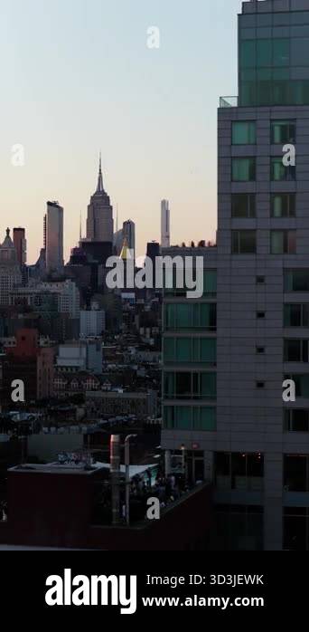 dusk casts pink hue over cityscape featuring towering glass buildings ...