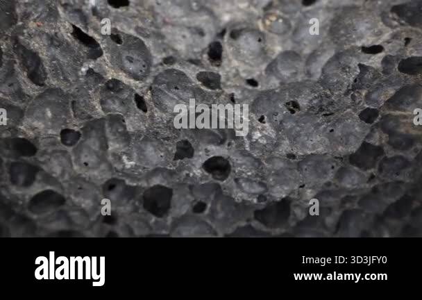 gray porous pumice stone as a volcanic igneous rock Stock Video Footage ...
