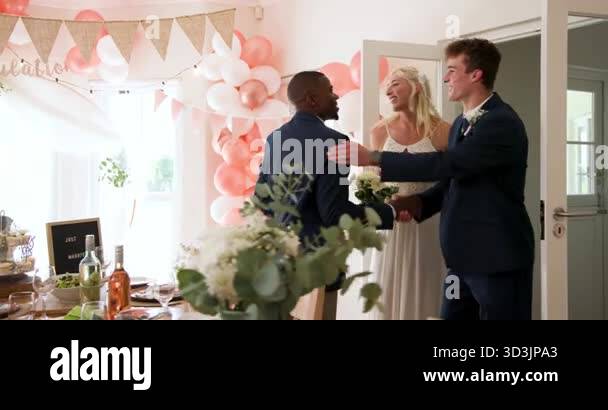 Diverse friends, celebrating, embracing at table at wedding ceremony at ...