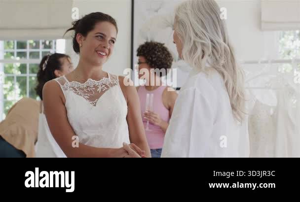 Diverse women entering bridal salon starting gown fitting with tape ...
