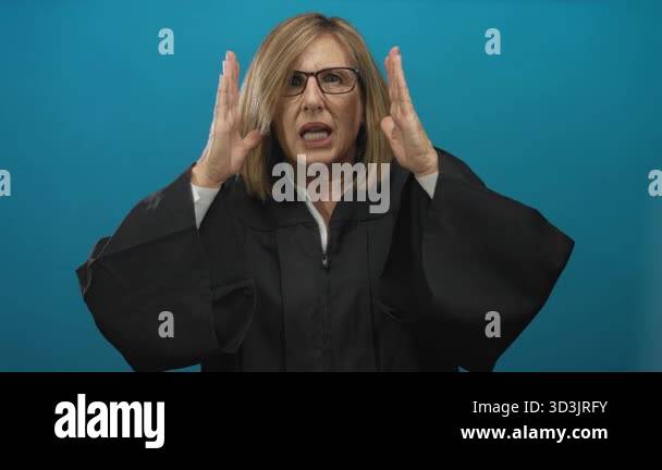Judge woman wearing black robe raises hands framing face showing ...