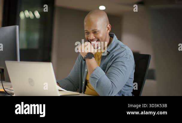 African American man leaning scanning laptop screen for project review ...