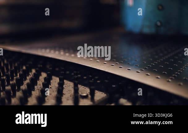 Close-up of an industrial turret punch press machine head working on a ...