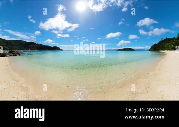 Sun reflection over transparent sea water and sandy beach in Tiamban ...