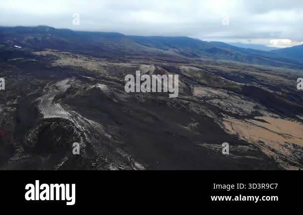 High altitude drone footage capturing the vastness of a desolate, rocky ...