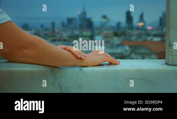 Closeup of womans hands resting on marble railing of cathedral rooftop ...