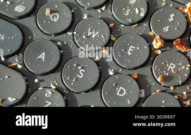 Watch as crumbs and dust are removed from a keyboard to improve use ...