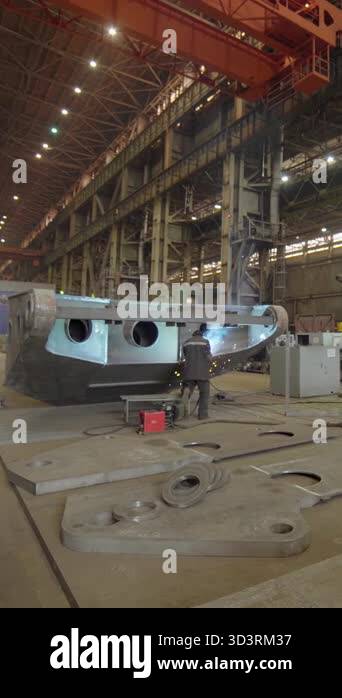 Workers welding metal parts of a ship inside a shipyard Stock Video ...