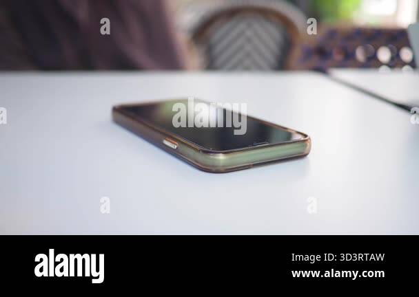 child hand reach for a Smartphone resting on a table Stock Video ...
