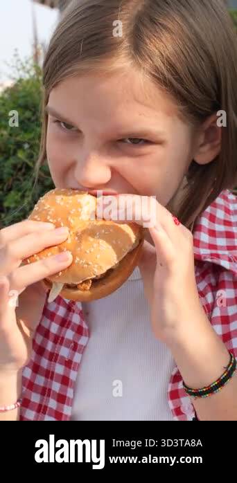 A cheerful lifestyle shot captures a preteen girl, dressed in a ...