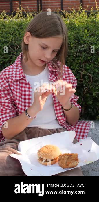 A cheerful lifestyle shot captures a preteen girl, dressed in a ...